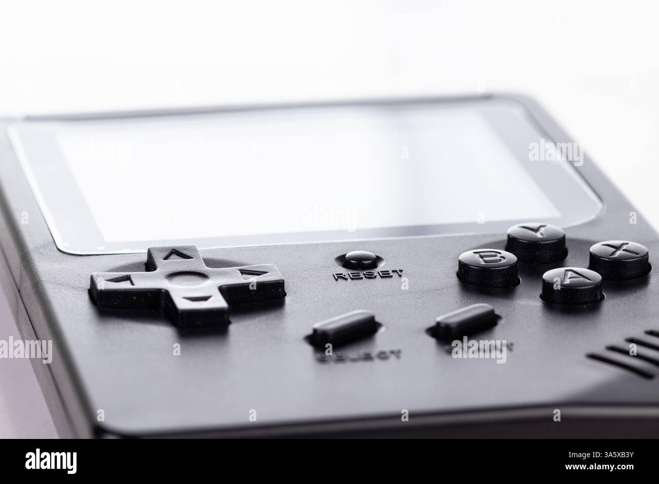 A stylized black retro handheld gaming console with classic buttons ...