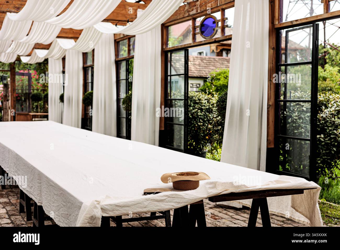 Cozy summer veranda featuring wooden accents, a long table with a white ...