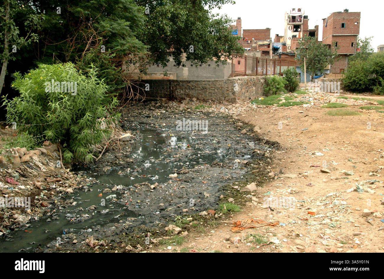 Nov 15, 2004; New Delhi, INDIA; A dirty water drain running near a ...