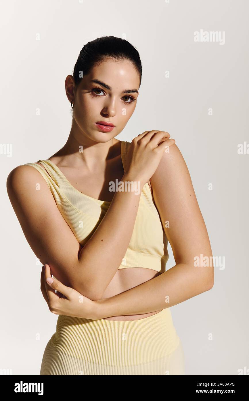 A young beautiful woman displays athletic style and poise while ...