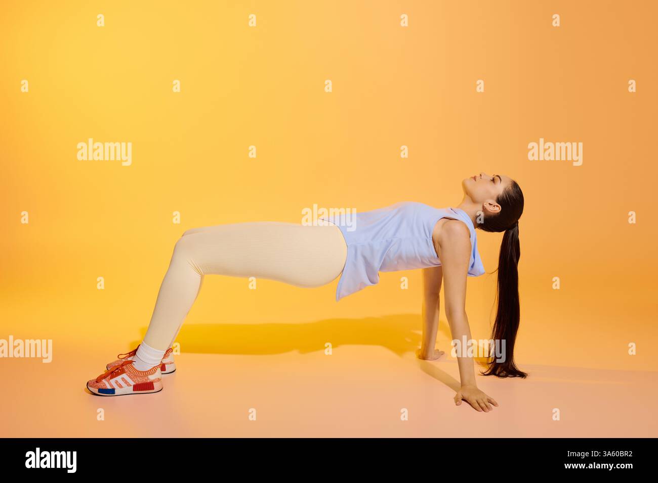 A confident young woman showcases her athletic skills while performing ...