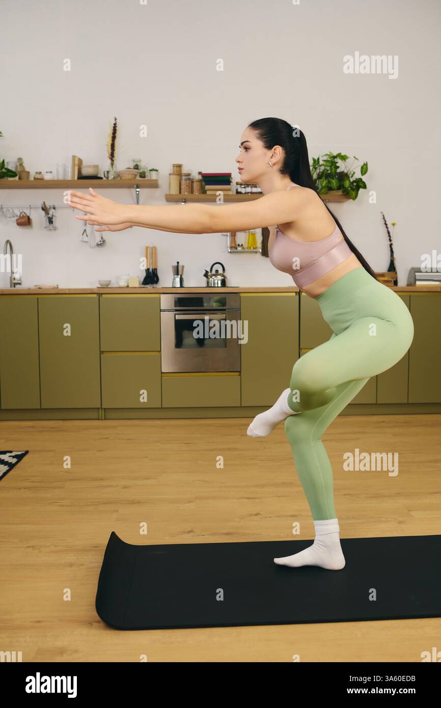 Young athletic woman demonstrates impressive balance and focus while ...