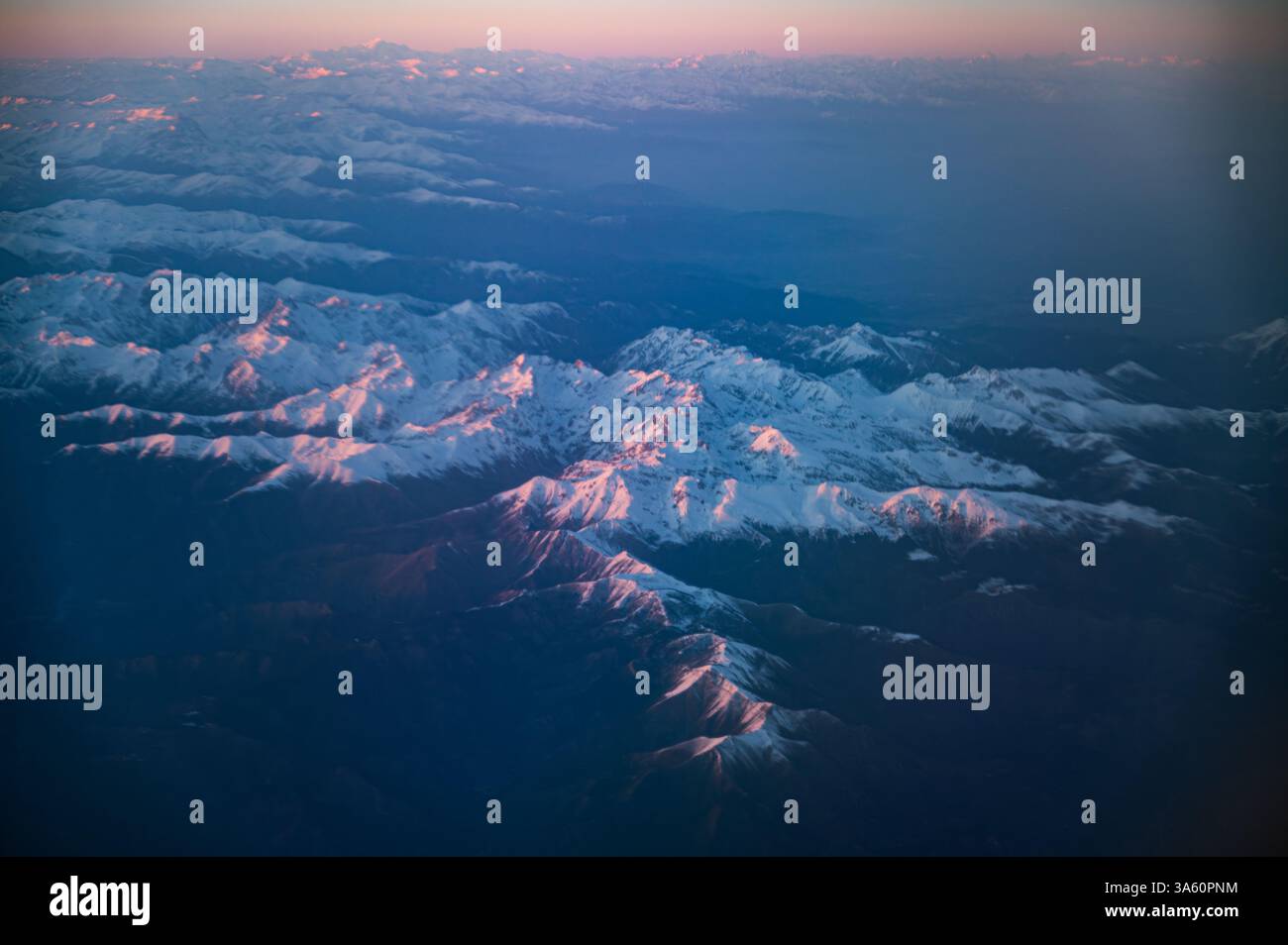 Unusual view from an airplane of the snowy Italian Alps, massive ridges ...
