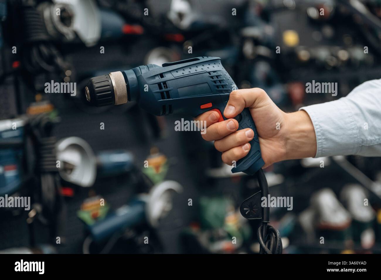 Perforator drill. Detailed close up view of man's hand in the hardware ...