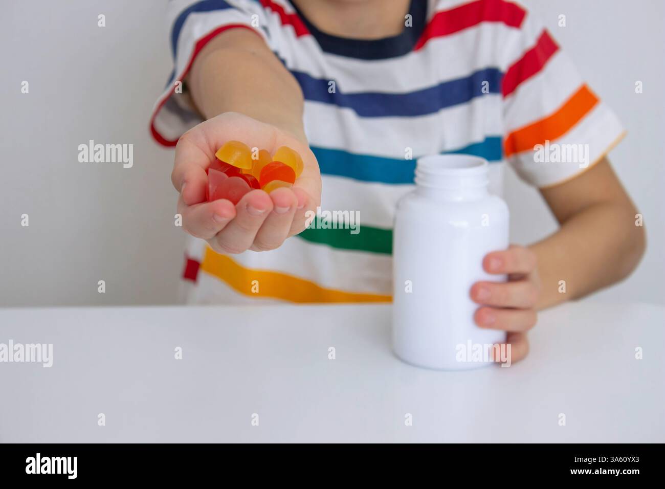 The boy eats jelly beans or takes vitamins Stock Photo - Alamy