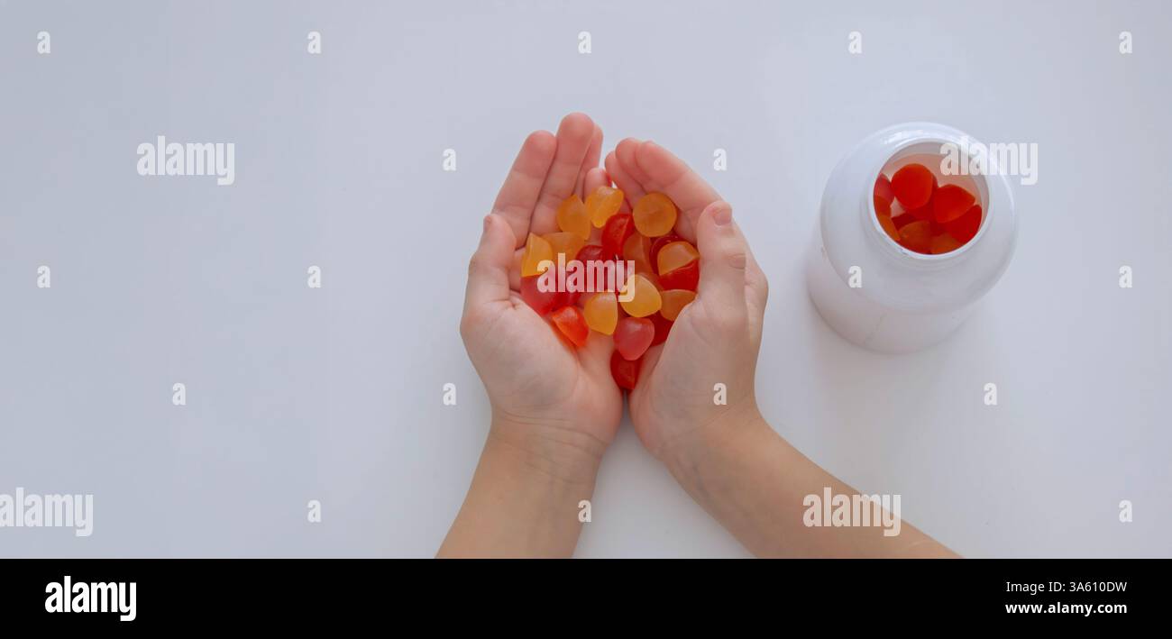 The boy eats jelly beans or takes vitamins Stock Photo - Alamy