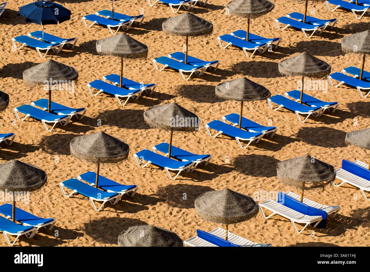 Cliffside, beachgoers and umbrellas at Praia dos Pescadores or ...