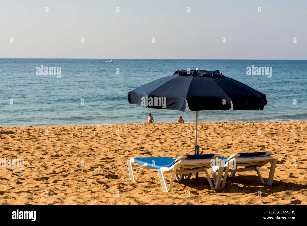 Cliffside, beachgoers and umbrellas at Praia dos Pescadores or ...