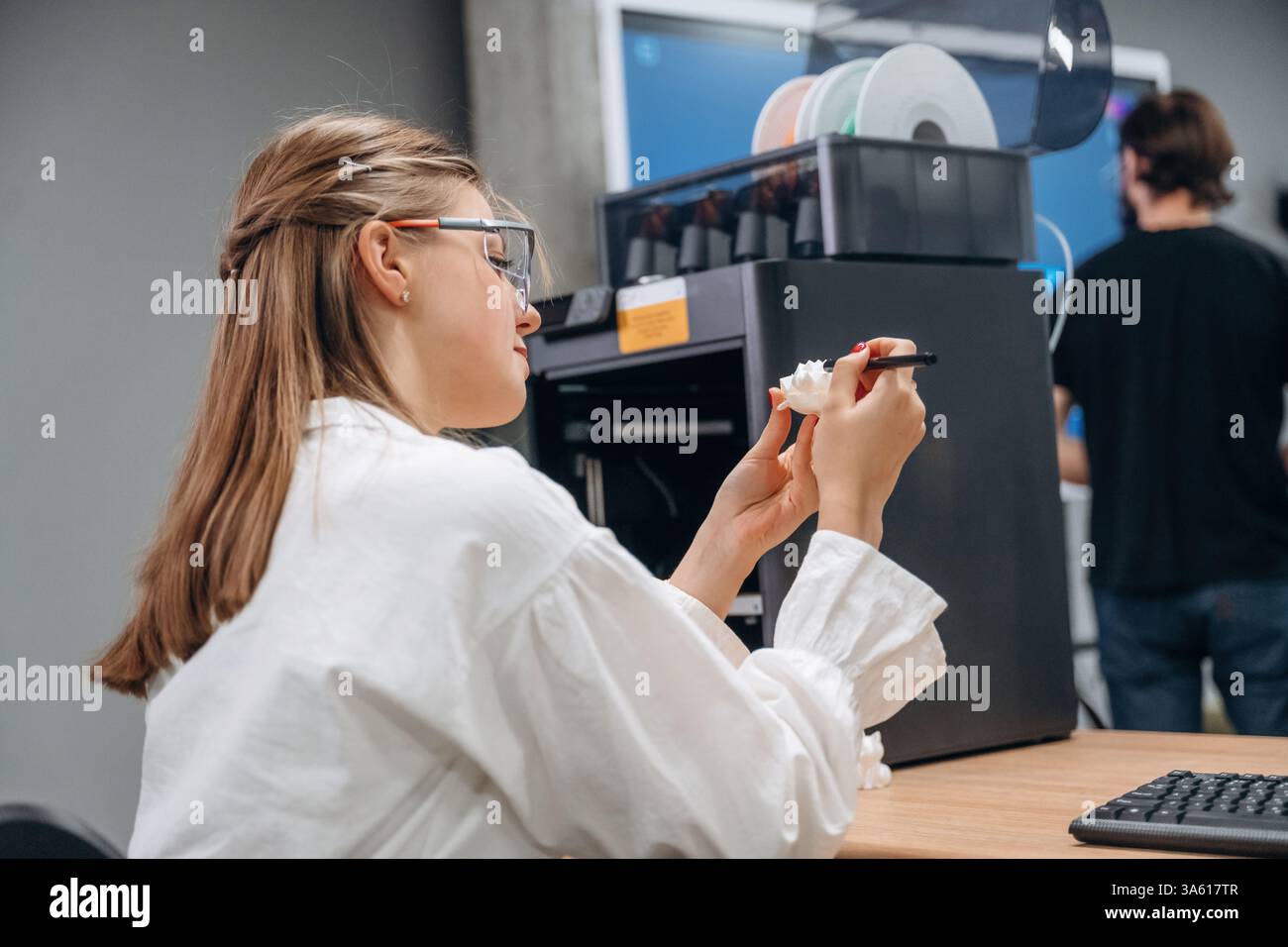 Painting the 3d printed turtle toy. Designer team are together in the ...