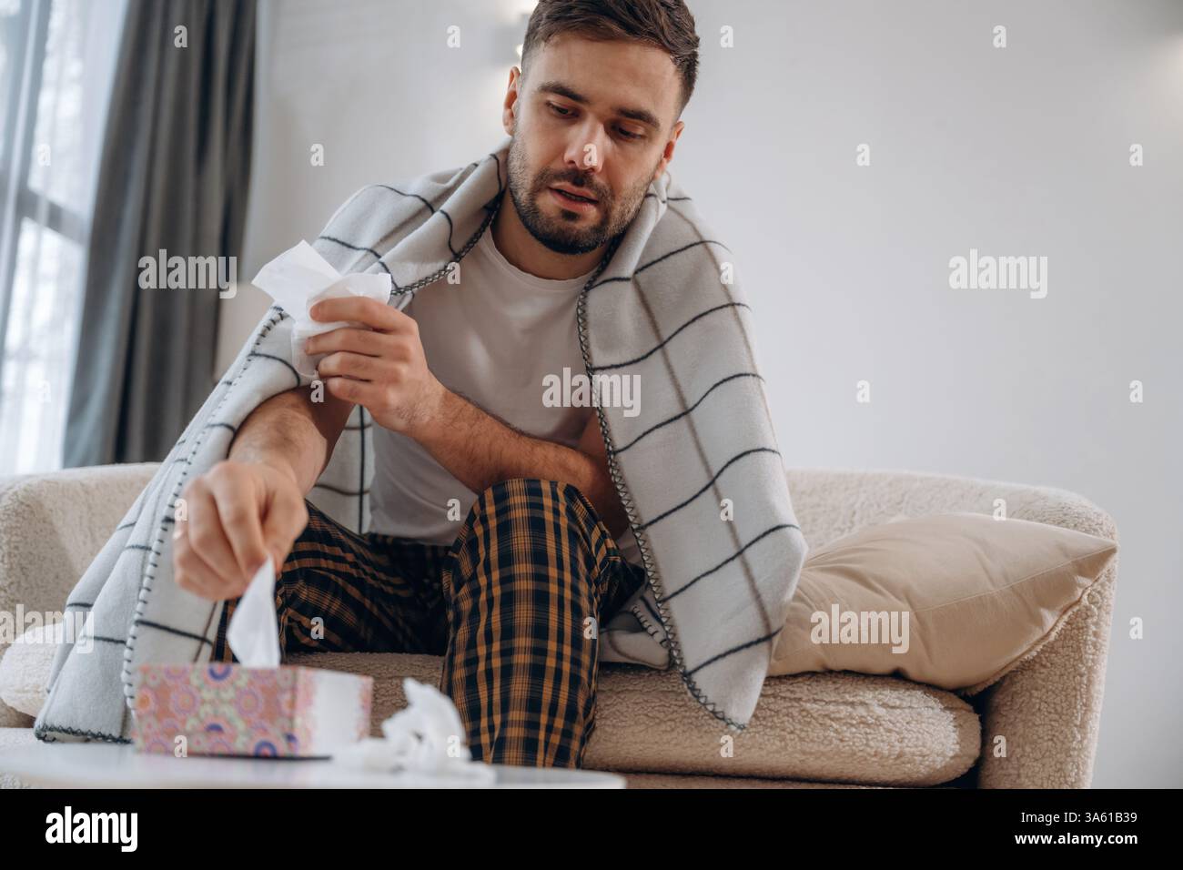 Front view, sitting. Sick man is feeling bad at home Stock Photo - Alamy