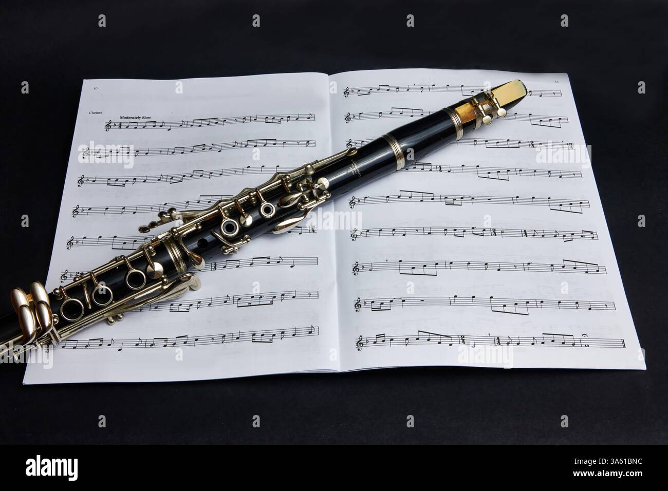 Clarinet still life on sheet music with a black background Stock Photo ...
