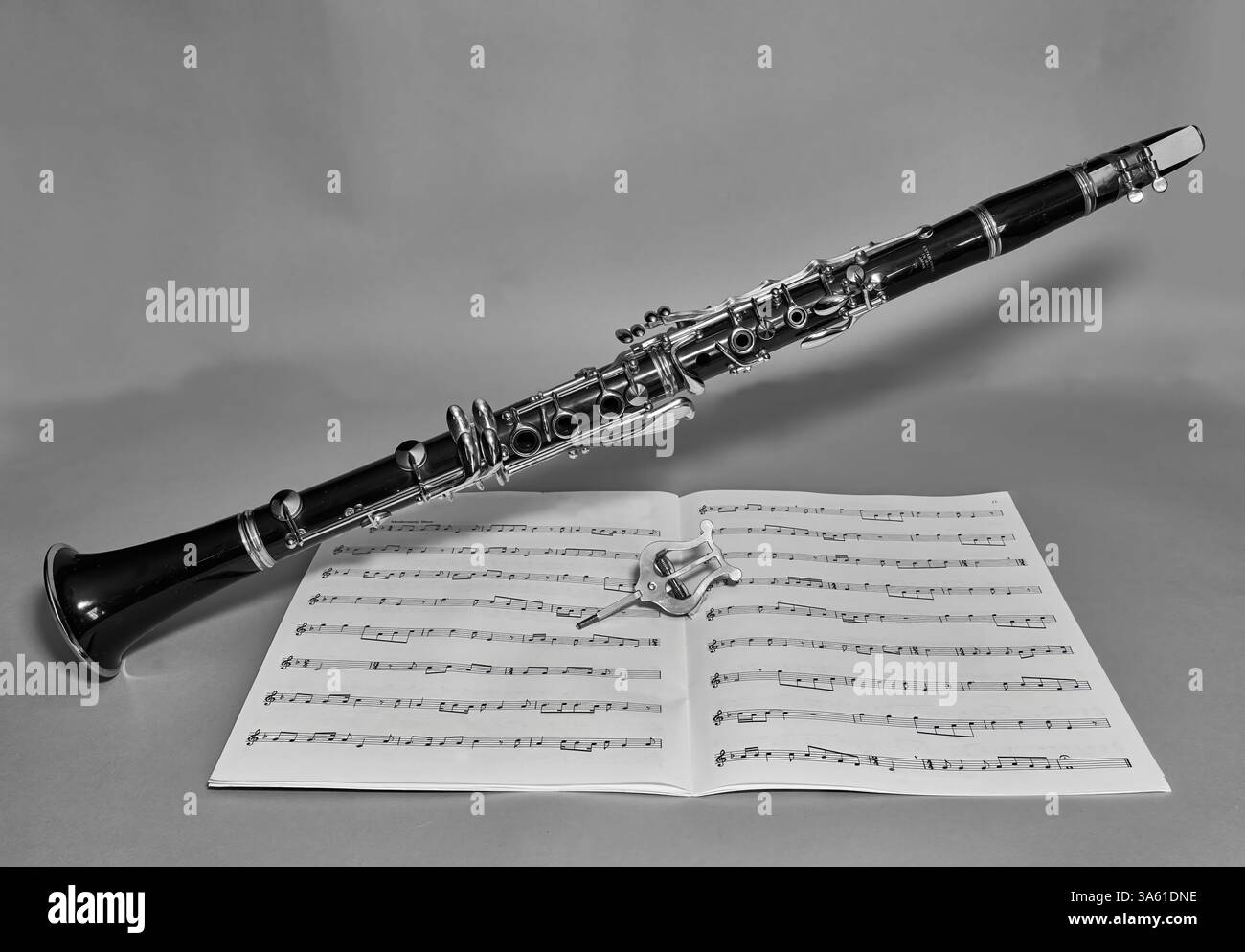 Clarinet black and white still life on sheet music with a black ...