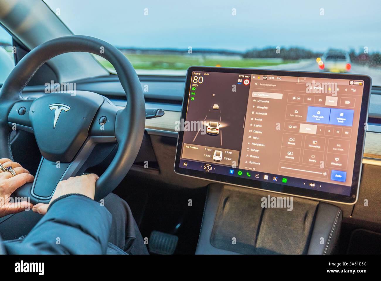 Close up view of Tesla Model Y interior with driver using touchscreen ...