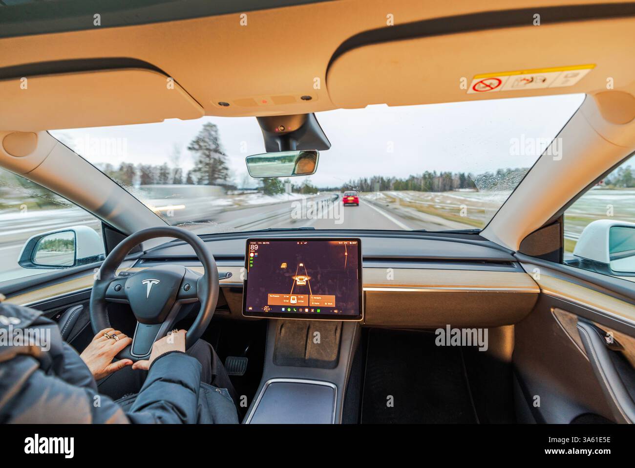 Woman driving tesla model autopilot hi-res stock photography and images ...