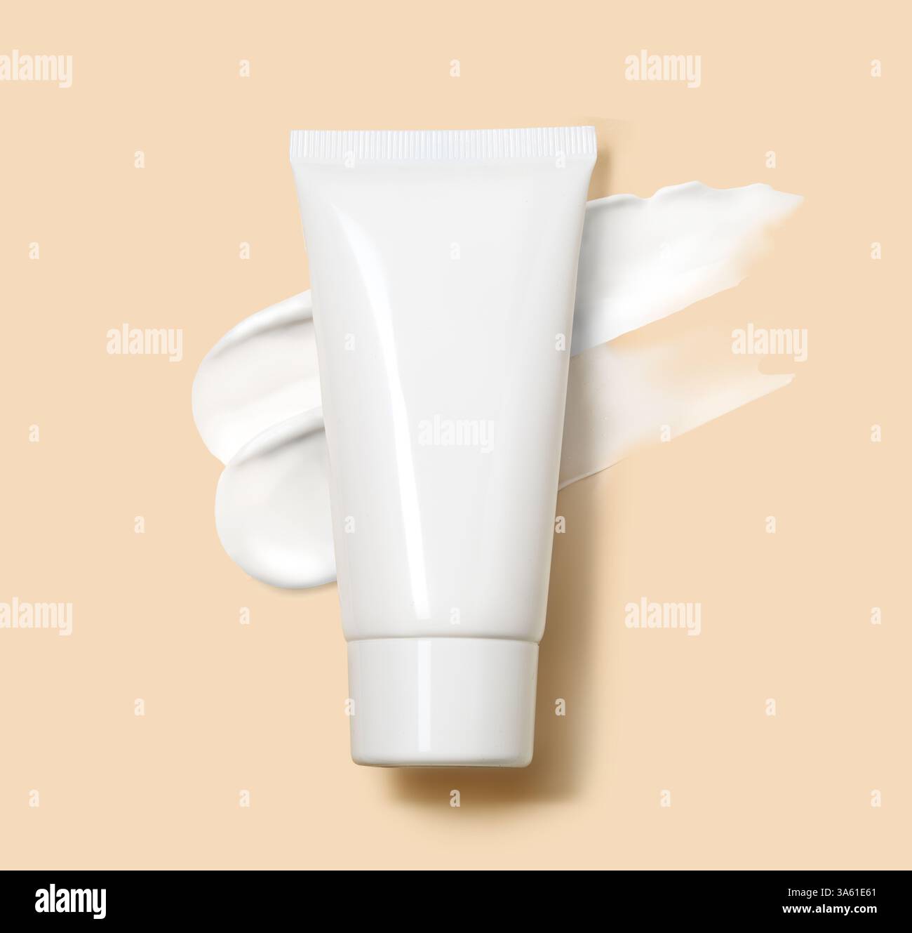 White cosmetic tube placed on an artistic background of a smear ...