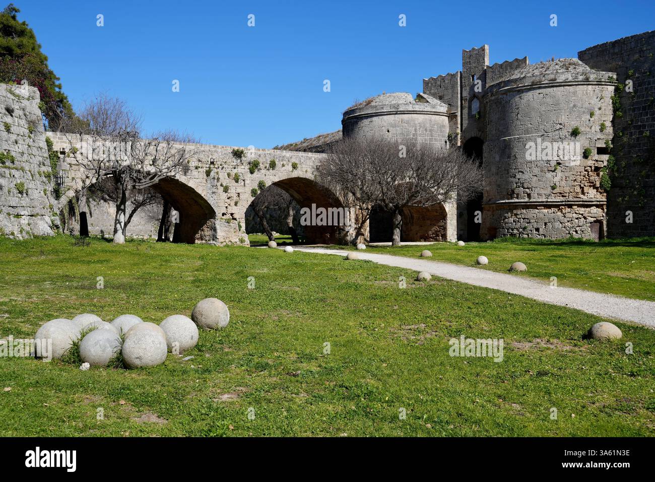 Stone bridge over the moat around the old town walls, with cannon balls ...