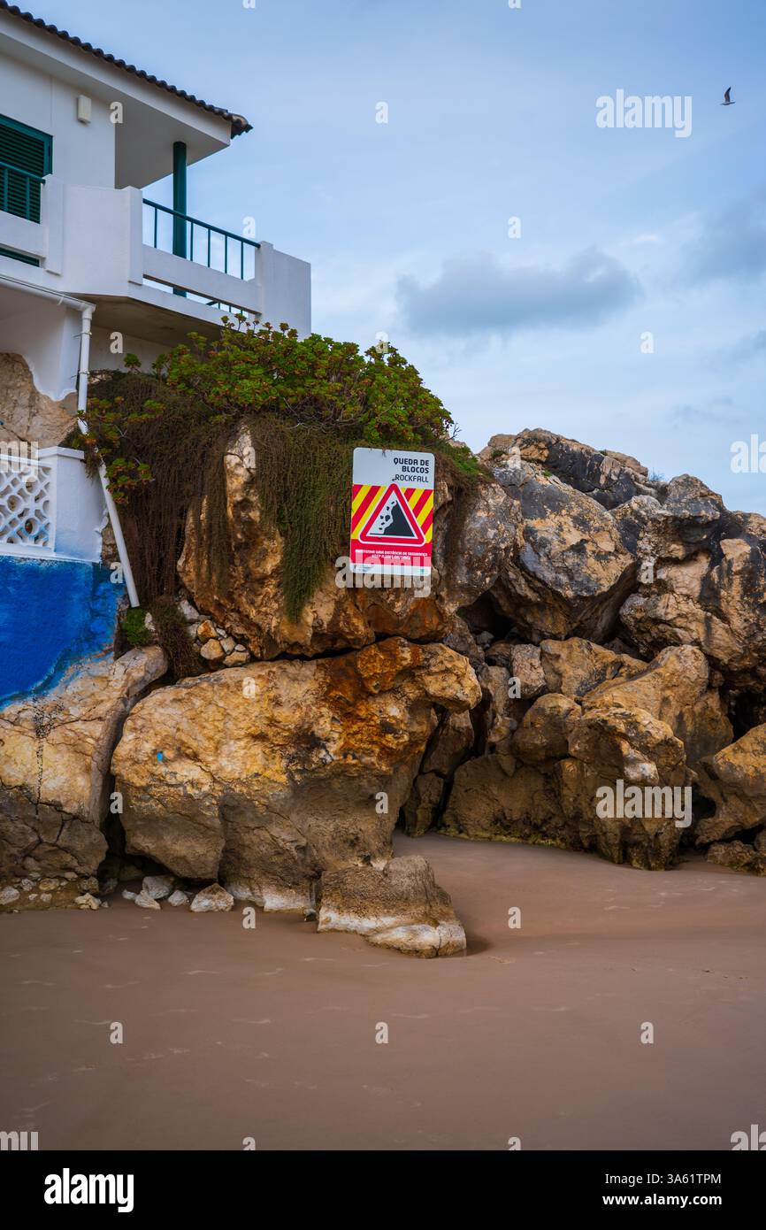 Rockfall danger sign, rocks and formations on Praia Baleal-Norte beach ...
