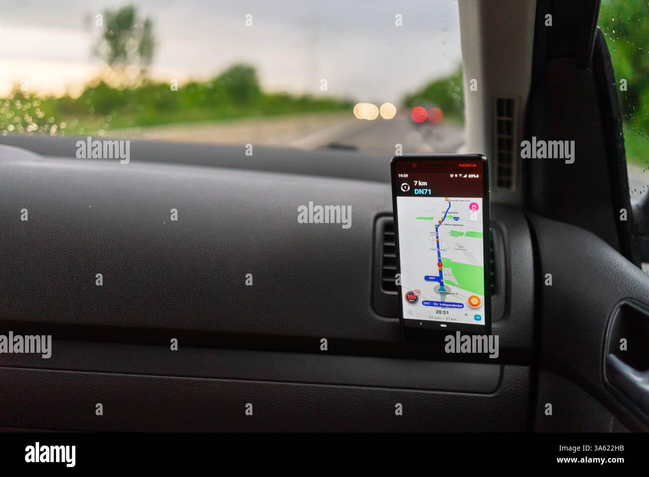 Using Waze maps application on smartphone on car dashboard Stock Photo ...