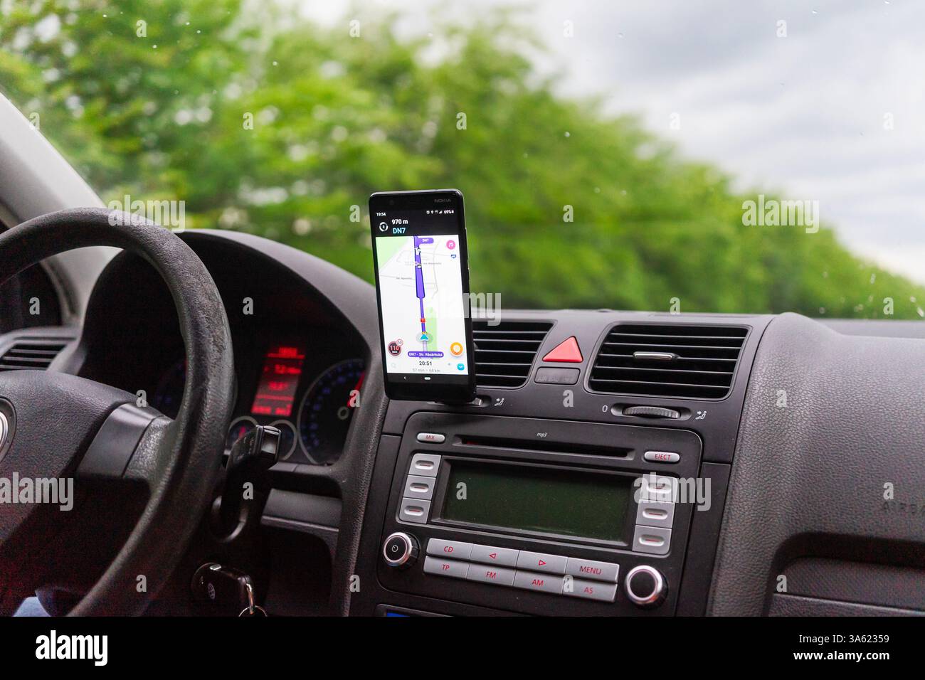 Using Waze maps application on smartphone on car dashboard Stock Photo ...