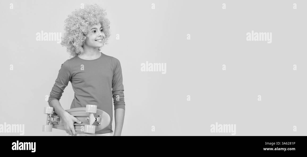 happy teen girl in fancy clown wig hold penny board, childhood. Funny ...