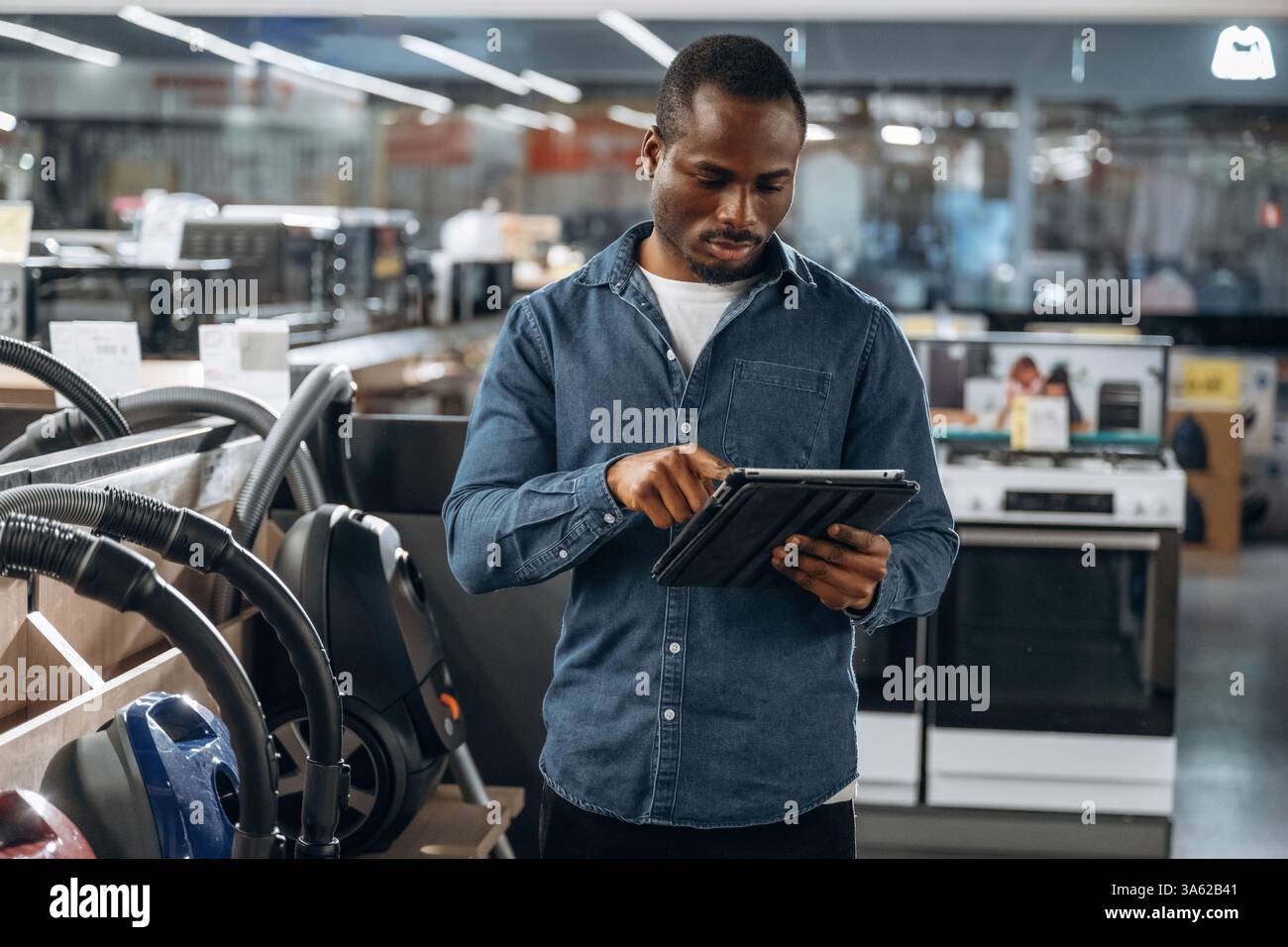 Worker is in the home appliance store Stock Photo - Alamy