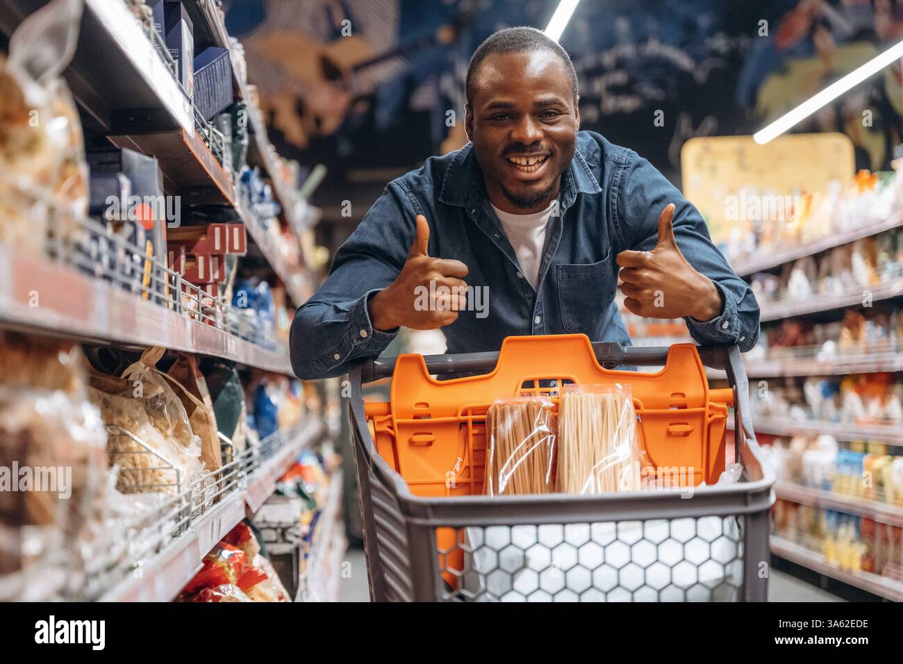 Smiling, positive facial expression. Man customer is in the supermarket ...