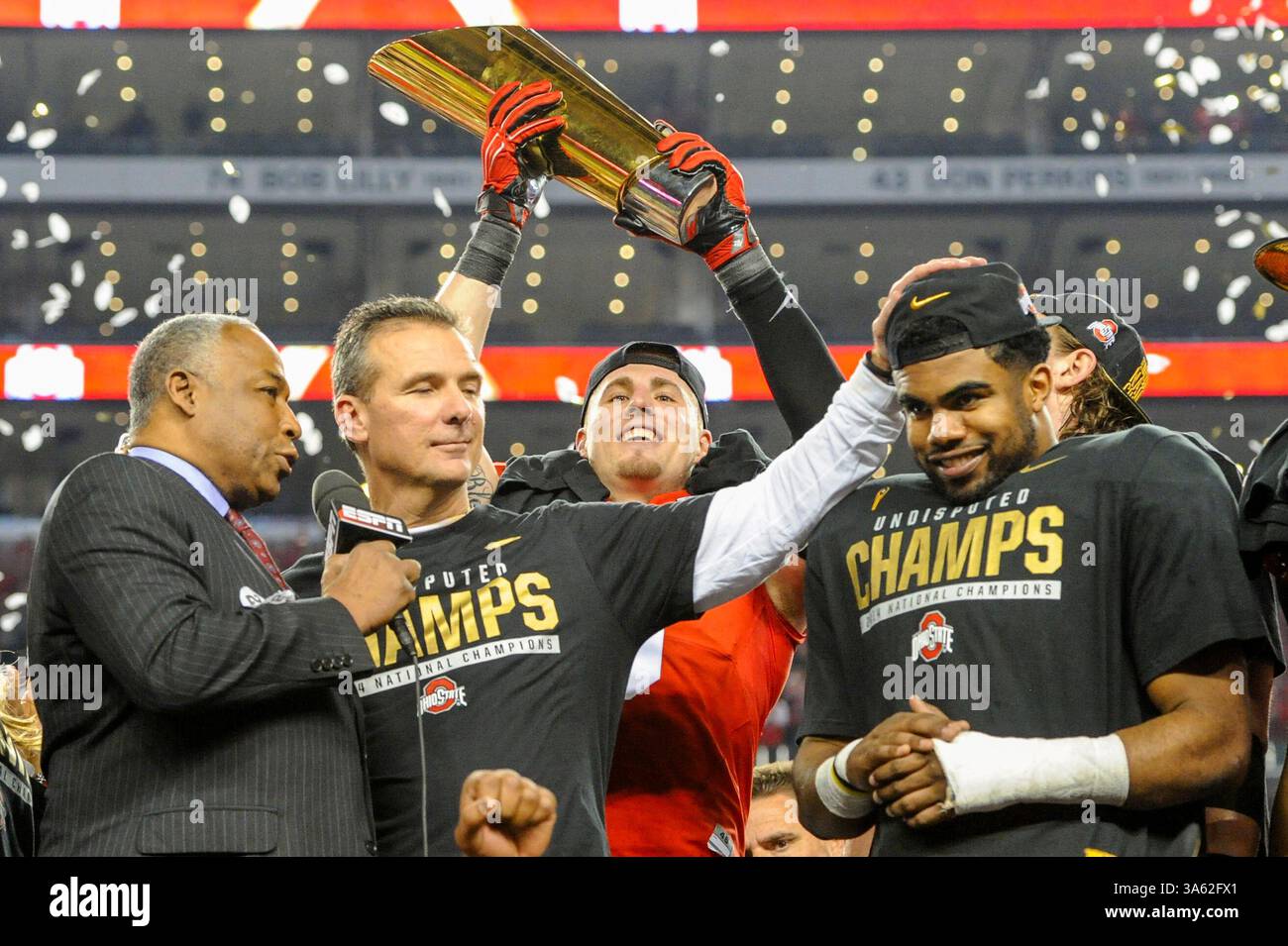 While Ohio State tight end Jeff Heuerman holds the Championship trophy ...