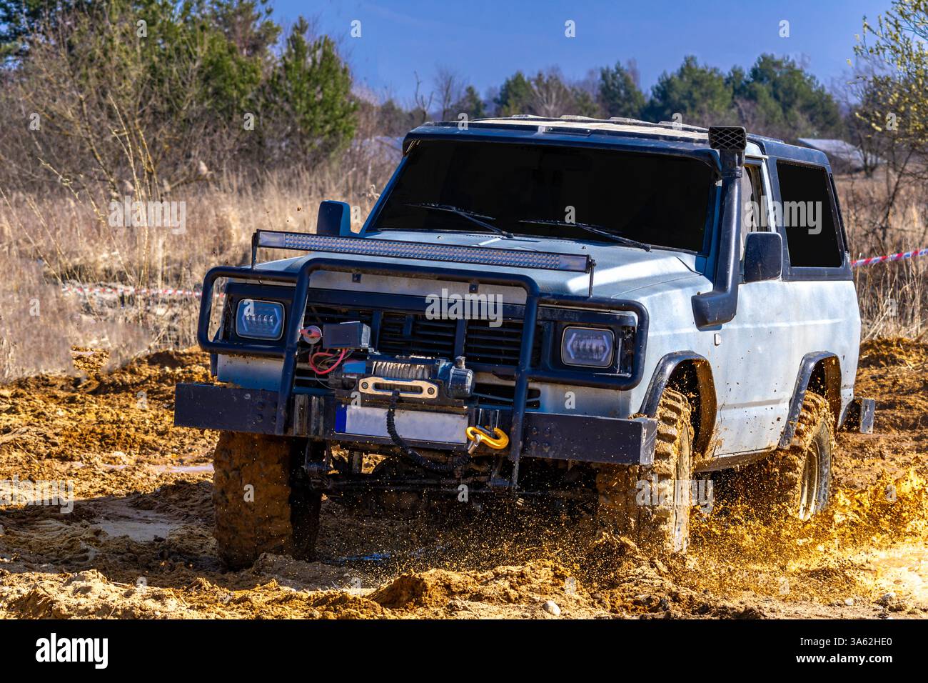 A large car adapted to driving in difficult terrain, overcoming mud ...