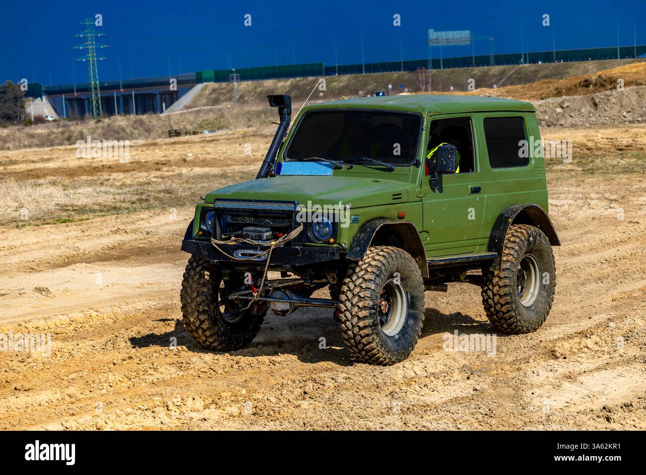 Green car prepared for driving in the desert with black windows, off ...