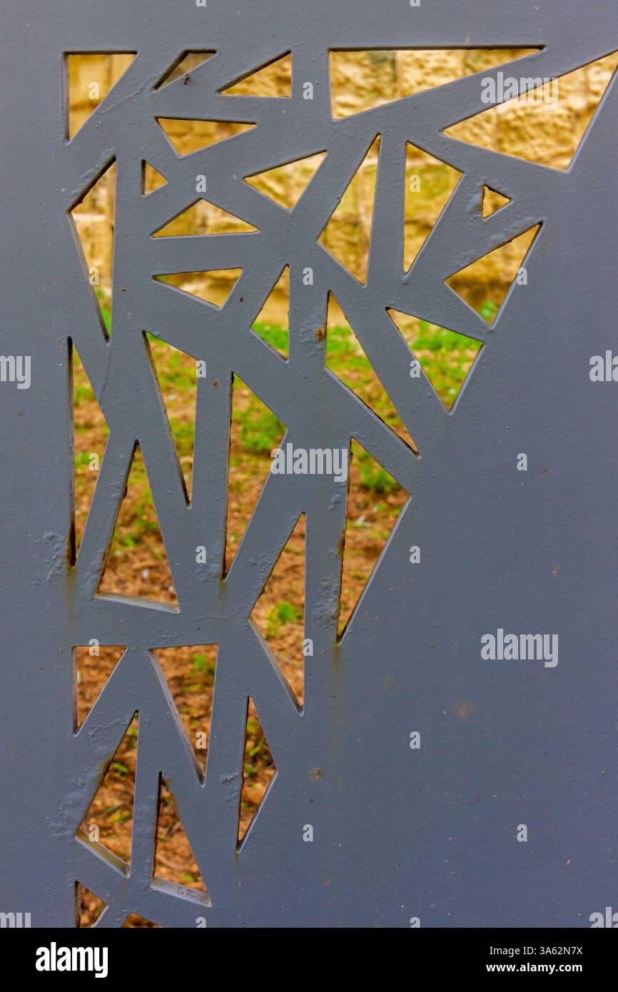 Geometric Metal Gate Panel with Abstract Cutouts in Outdoor Environment ...