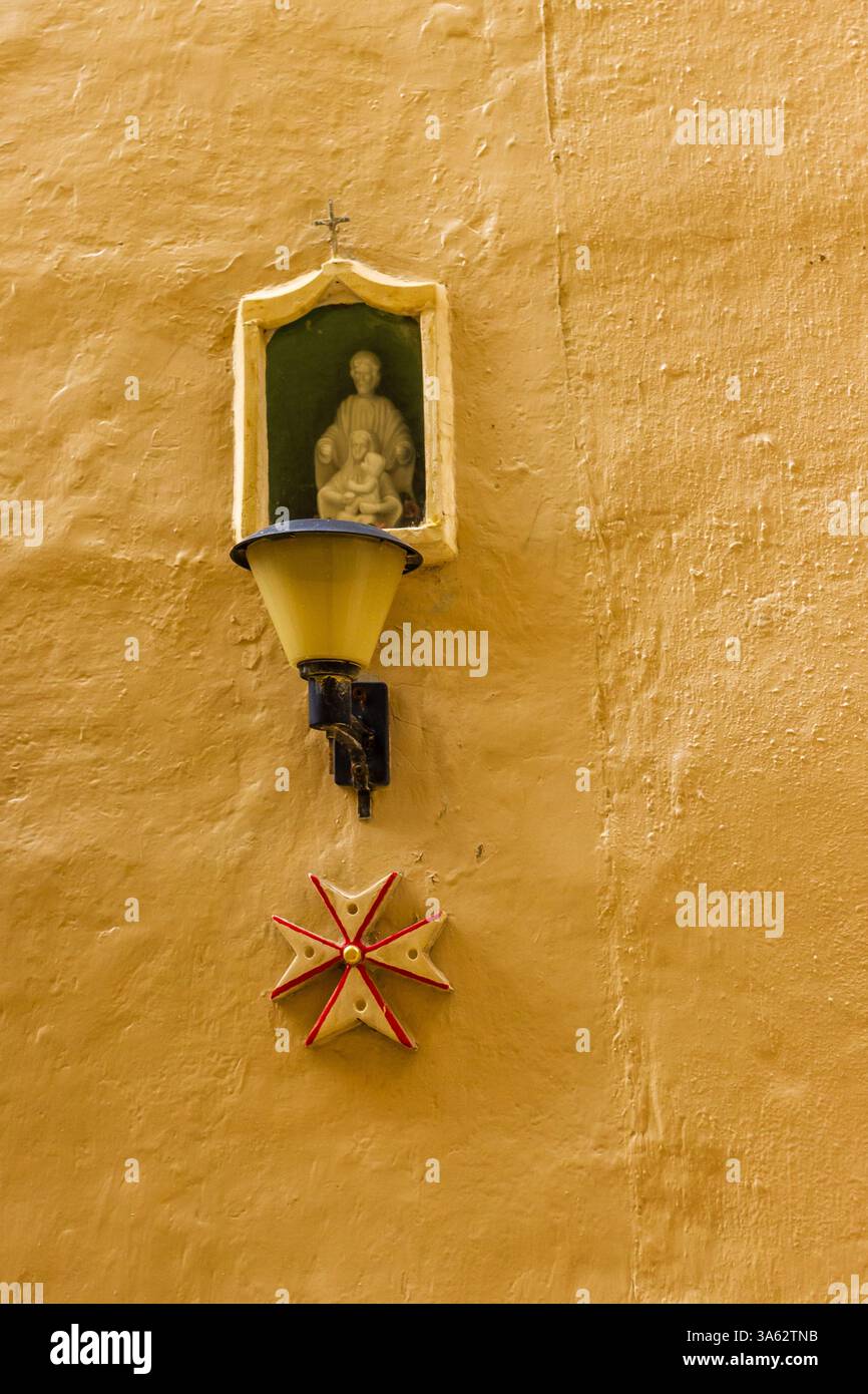 Stone Wall Niche with Religious Statue and Illuminated Malta Cross ...