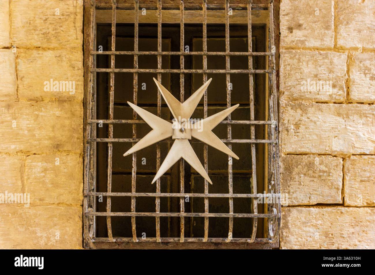 Iron Window Grates Decorated with a Starburst Ornament on Stone Wall ...