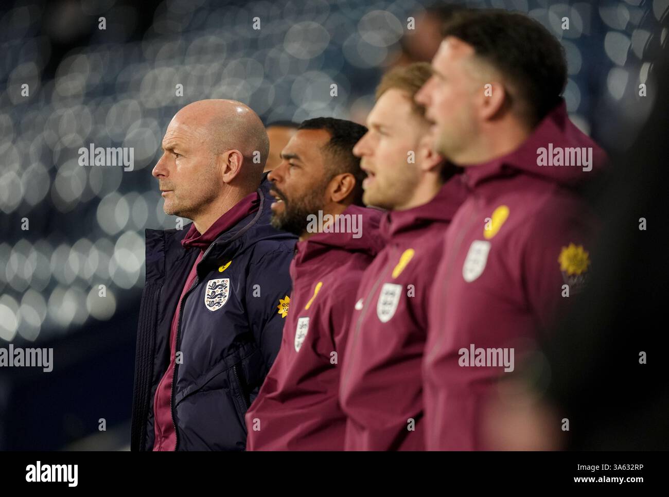 England's coaching team during the national anthem before an ...