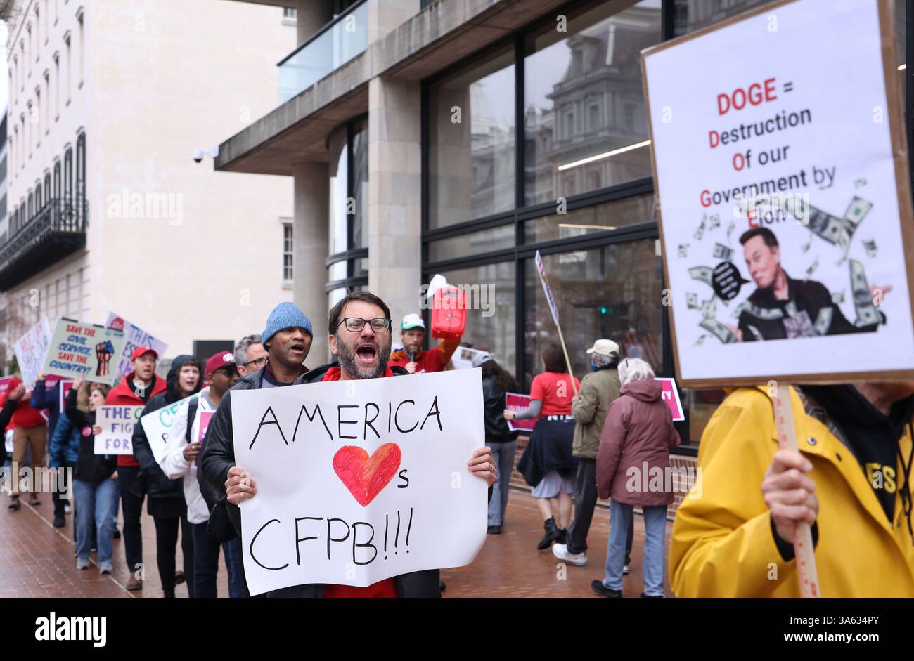 Washington Dc, Virginia, USA. 24th Mar, 2025. Demonstrators hold signs ...