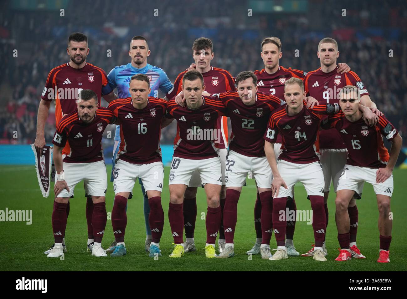 Latvia starting players pose for a team photo at the beginning of a ...