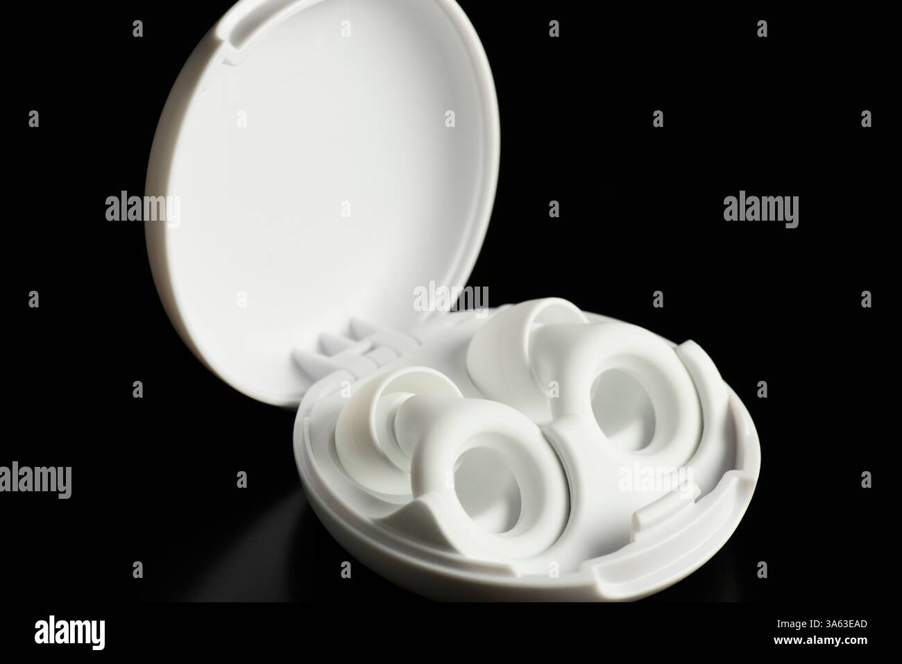 White Loop Quiet earplugs and carry case on black Stock Photo - Alamy