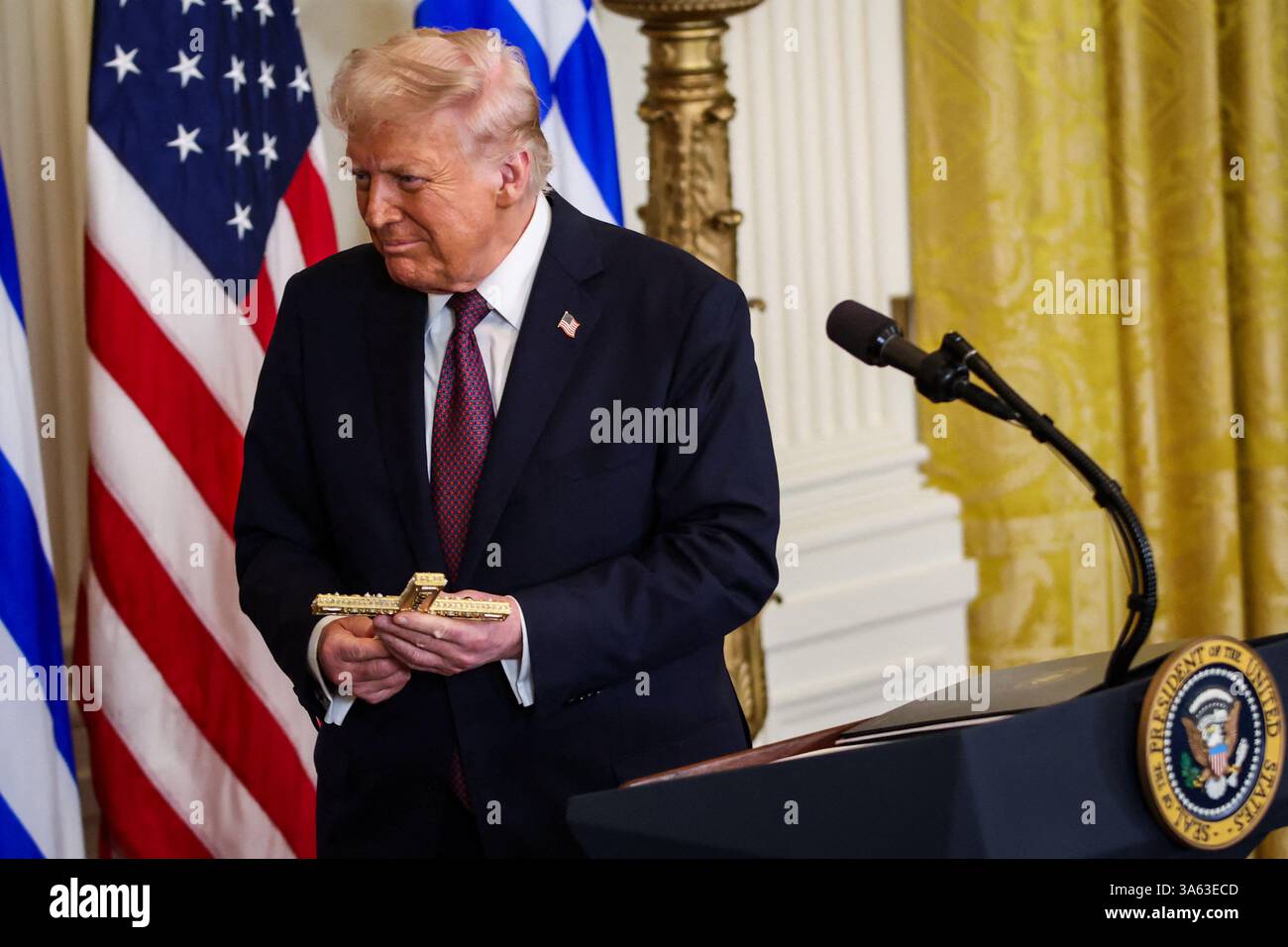 Washington, United States. 24th Mar, 2025. President Donald Trump holds ...
