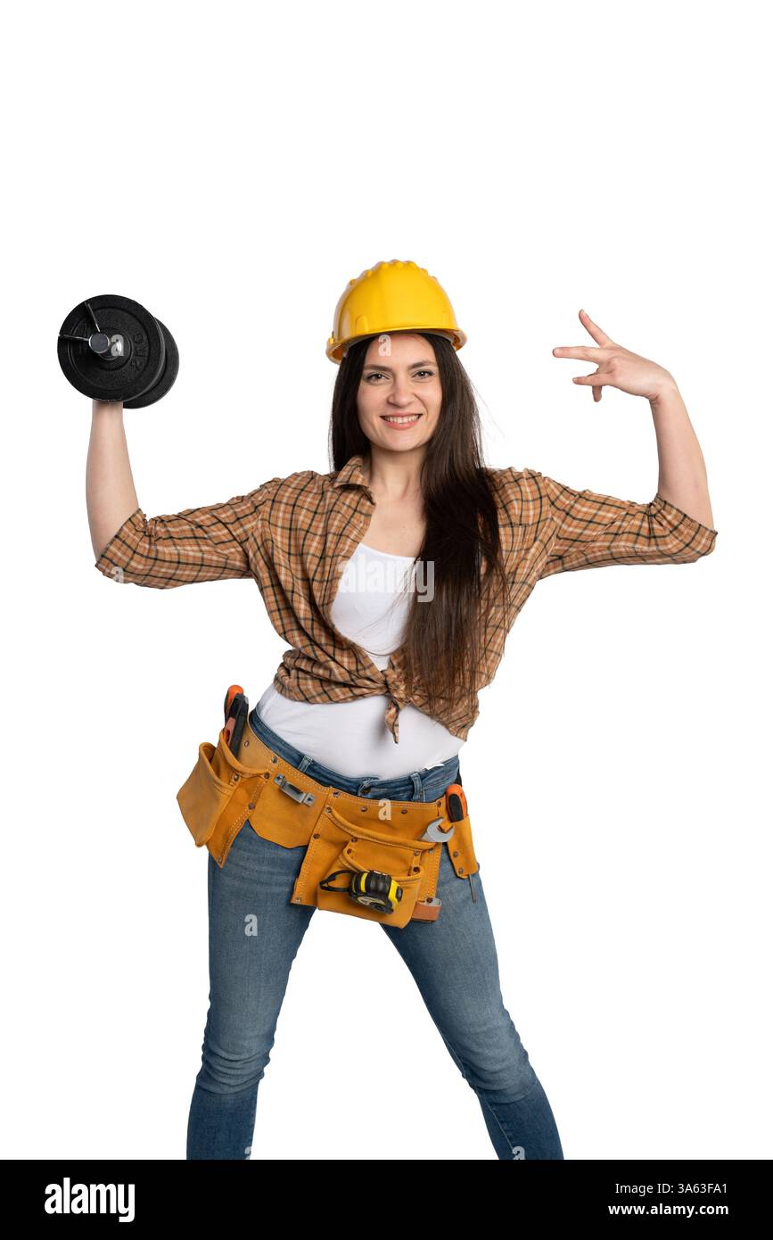 A cheerful female construction worker wearing a yellow hard hat and ...