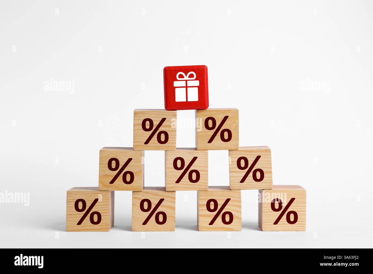 Red cube with gift box image on top of pyramid of other ones with ...