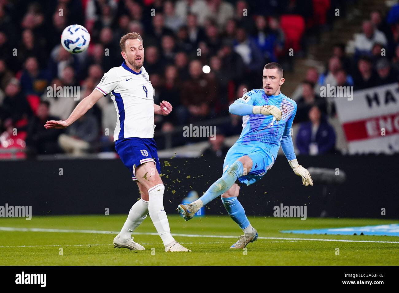 Latvia goalkeeper Krisjanis Zviedris (right) is closed down by England ...