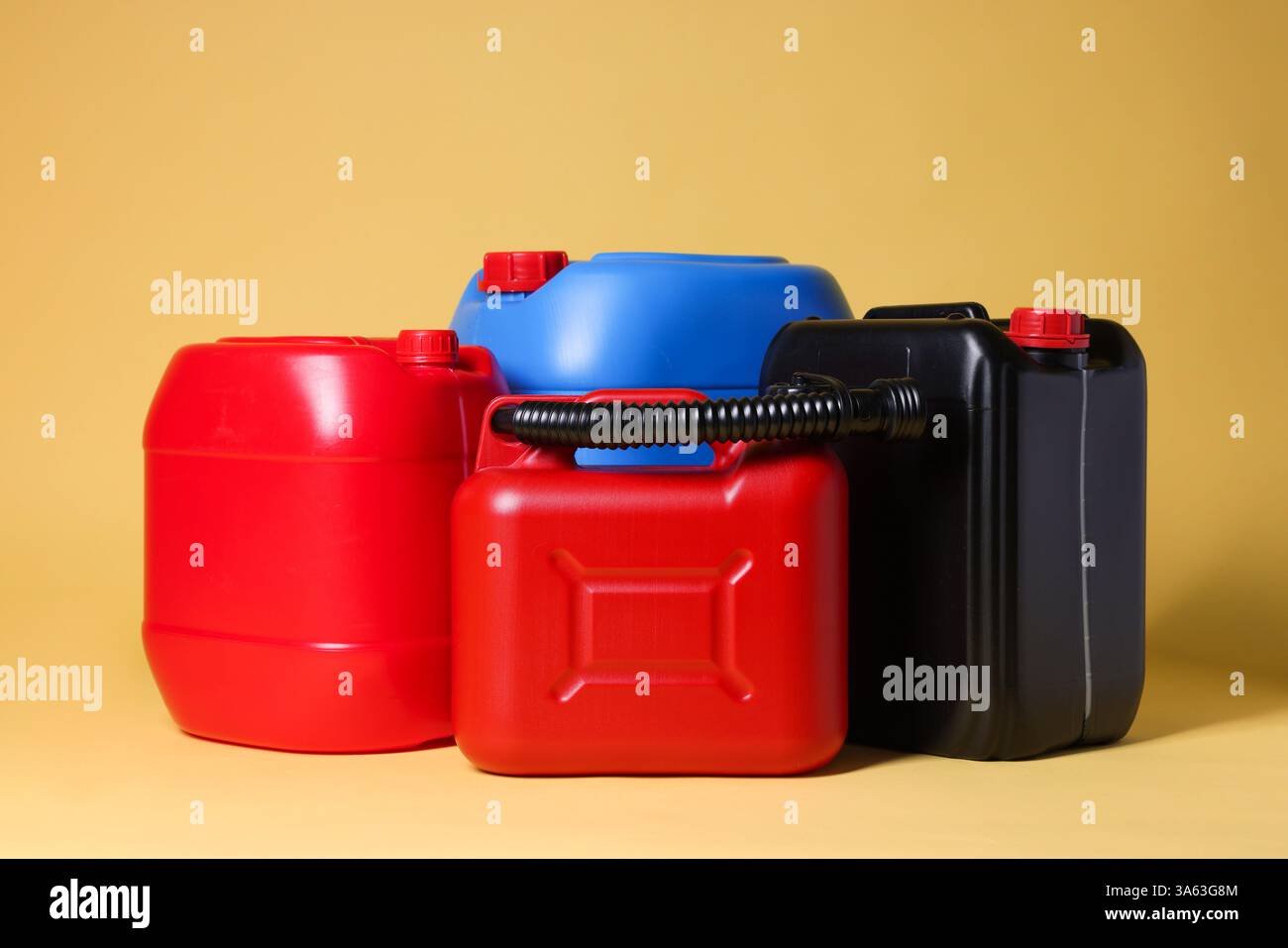 Many different plastic canisters on yellow background Stock Photo - Alamy