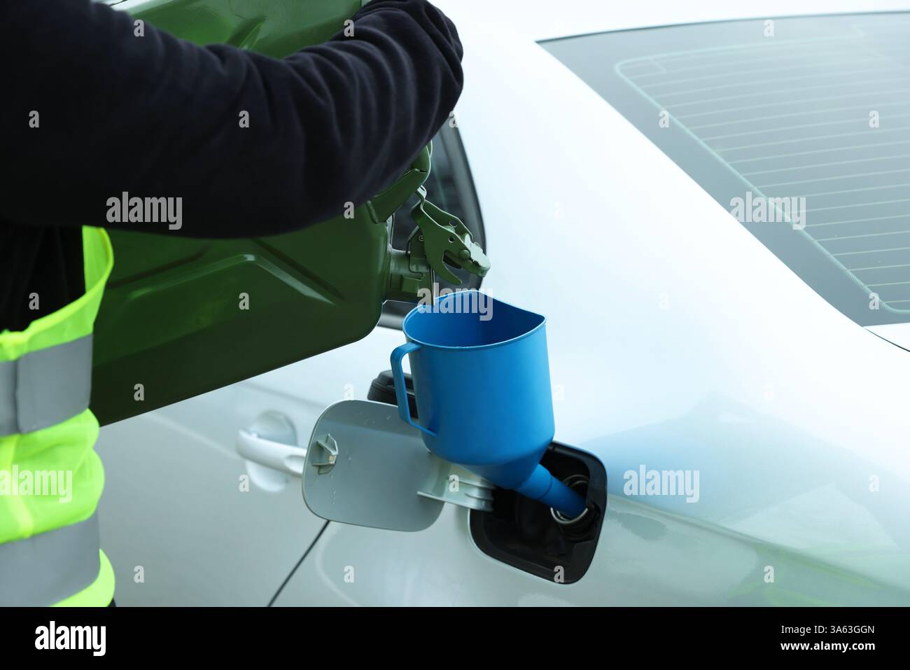 Man pouring fuel from canister into funnel outdoors, closeup Stock ...