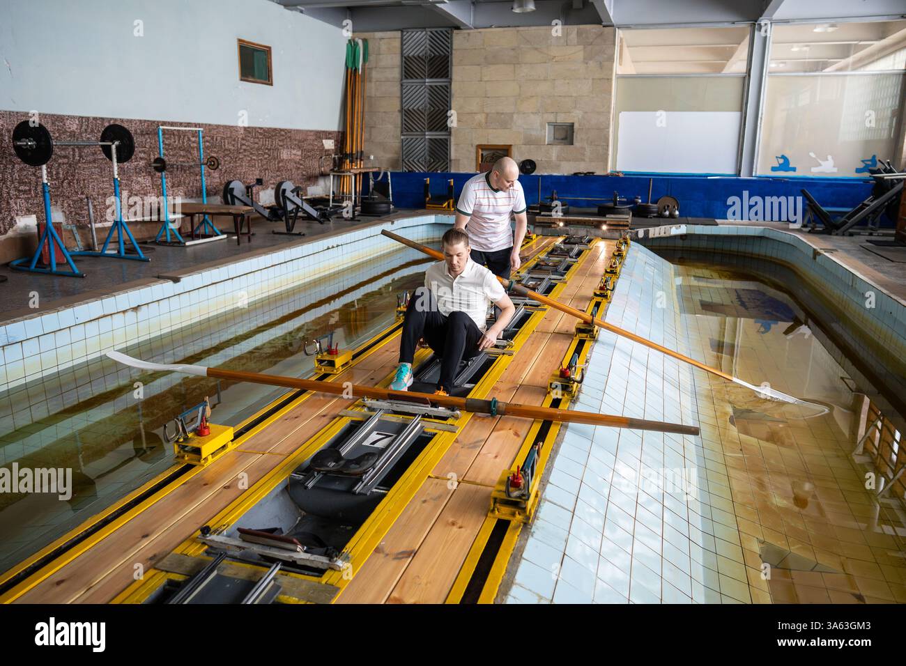 Group of swimmer athletes position properly for rowing simulator ...