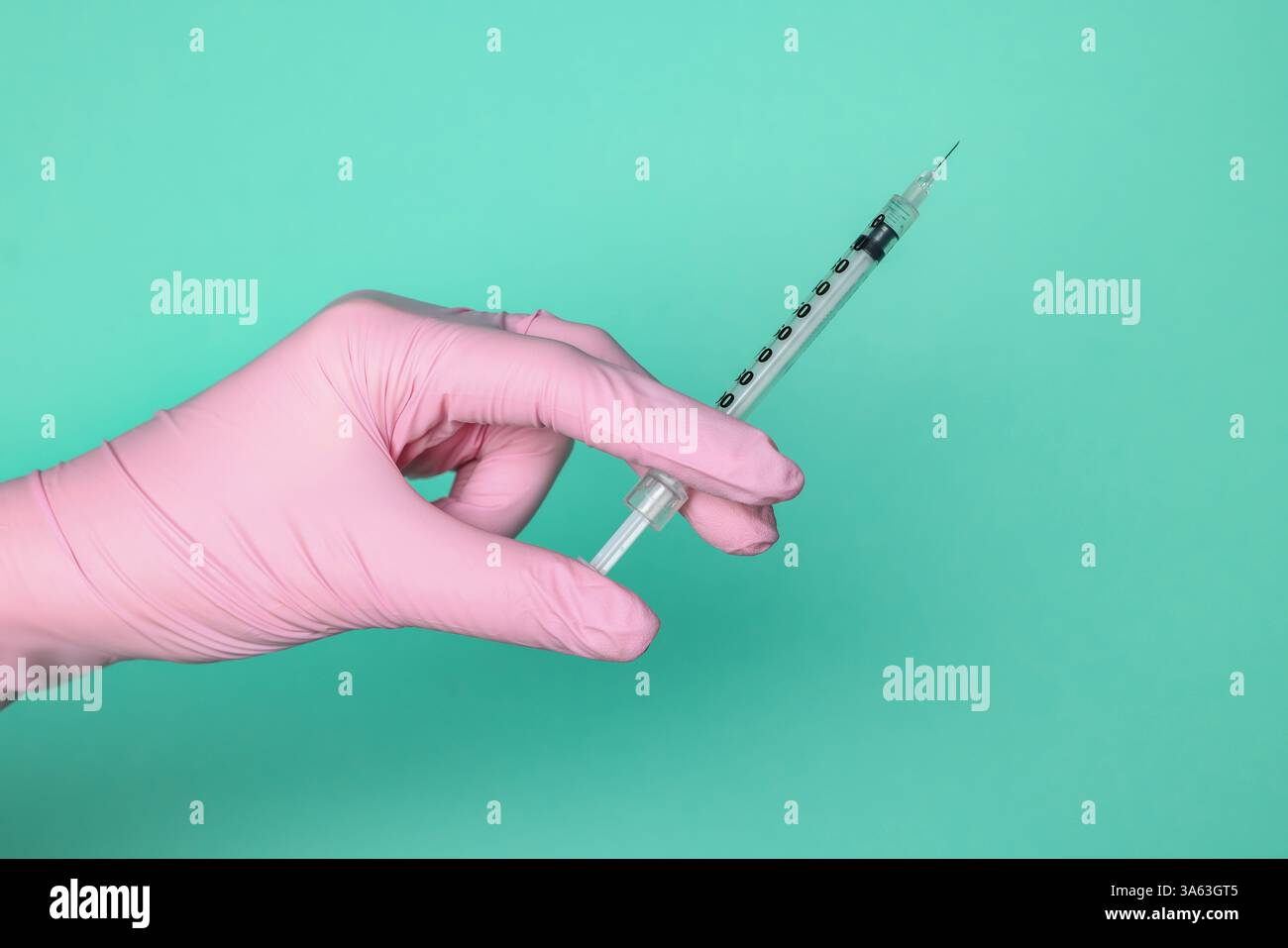 Doctor holding syringe with medication on turquoise background, closeup ...
