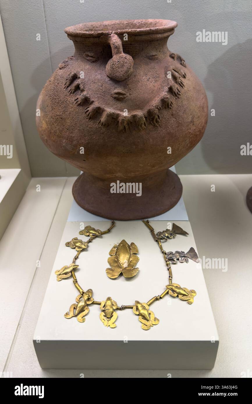 A necklace of gold frogs & ceramic pot from the Pre-Hispanic indigenous ...