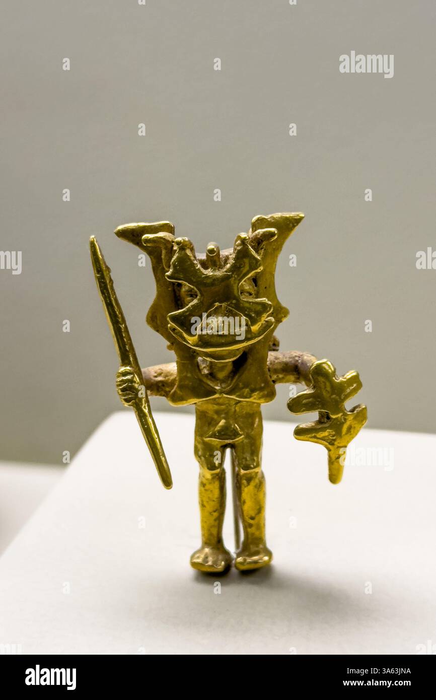 Gold figurine wearing a mask from the Pre-Hispanic indigenous Calima ...