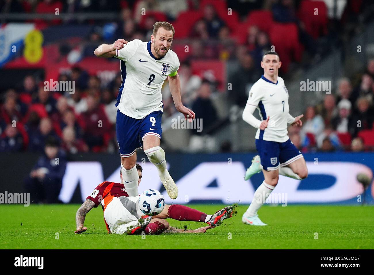 England's Harry Kane (top left) is fouled by Latvia's Deniss Melniks ...