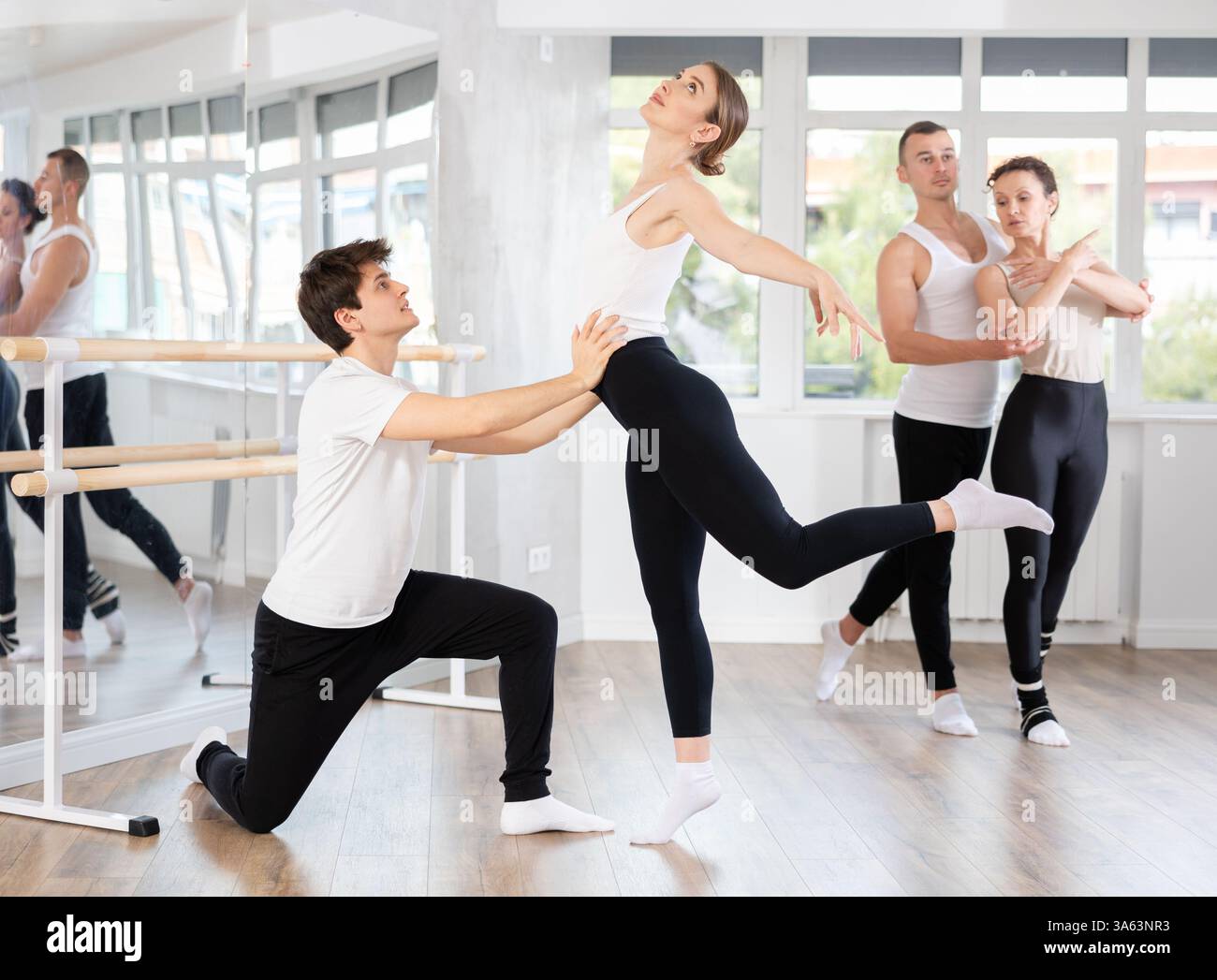 Diligent couple of athletic modern ballet dancers practicing ballet ...