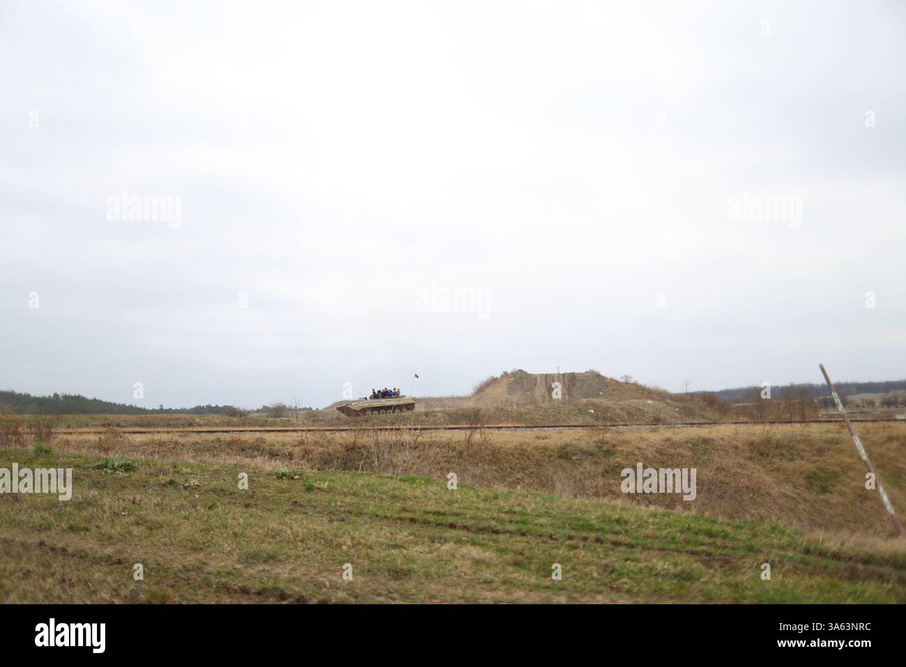rear profile of commander and gunner directing action tank on a ...