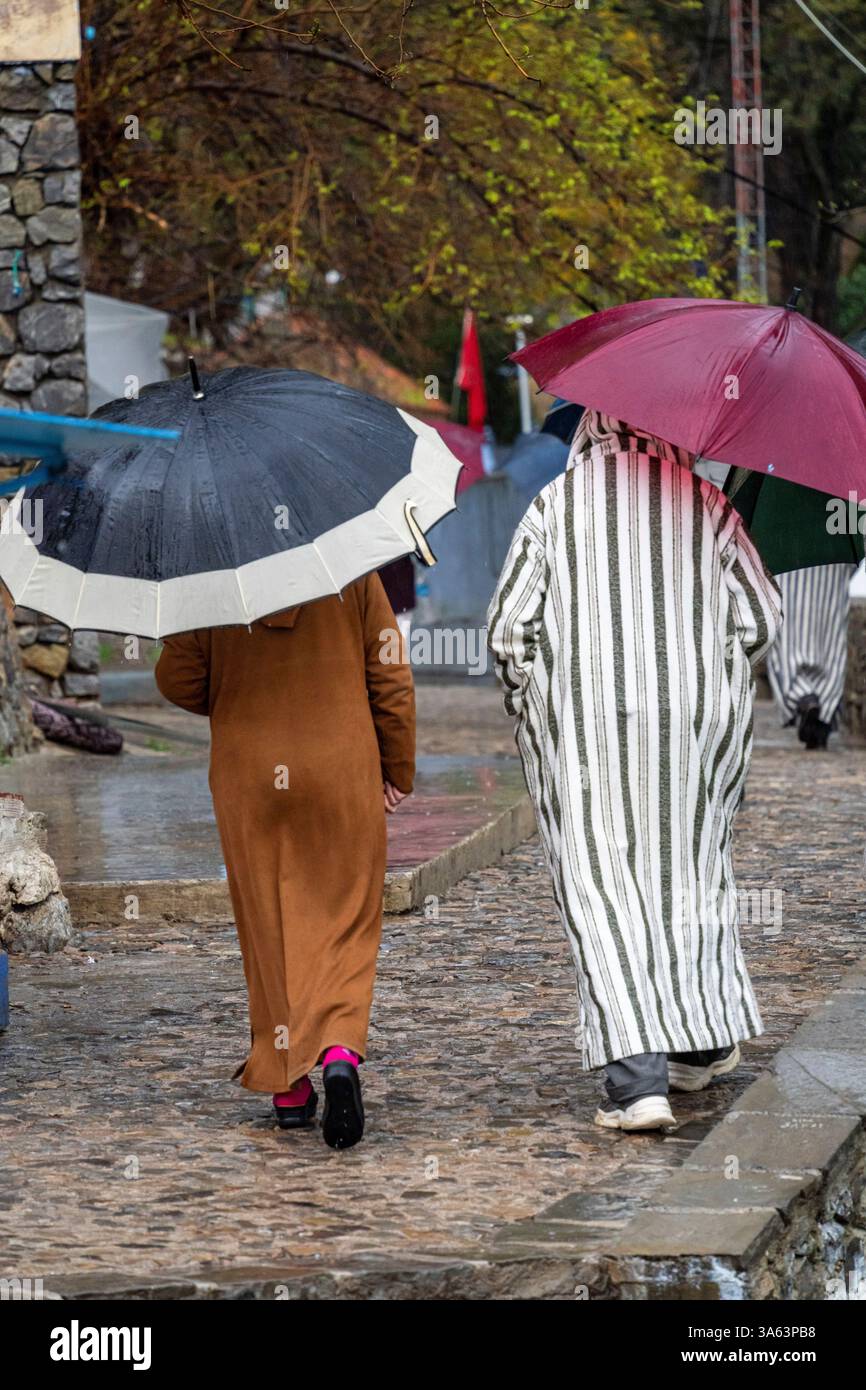 People with umbrellas in the rain, Ras el Maa, Chefchaouen, Rif ...